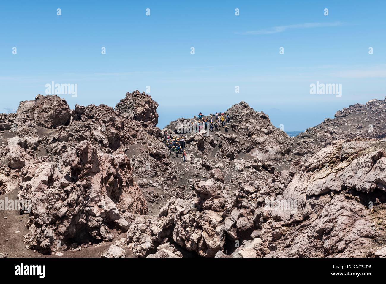 A group of hikers in the wild and surreal volcanic landscape at 3200m ...