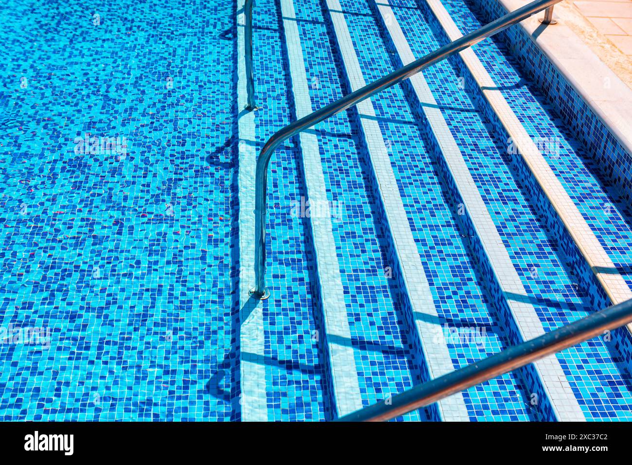 Swimming pool with staircase and a ladder in transparent water Stock ...