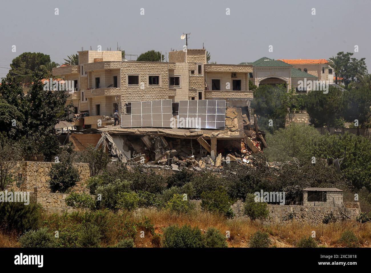 Janta, Lebanon. 14th June, 2024. A pro-Iranian Hezbollah militant walks ...