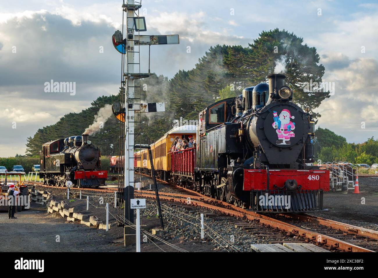 A steam train decorated for Christmas and carrying a load of passengers ...