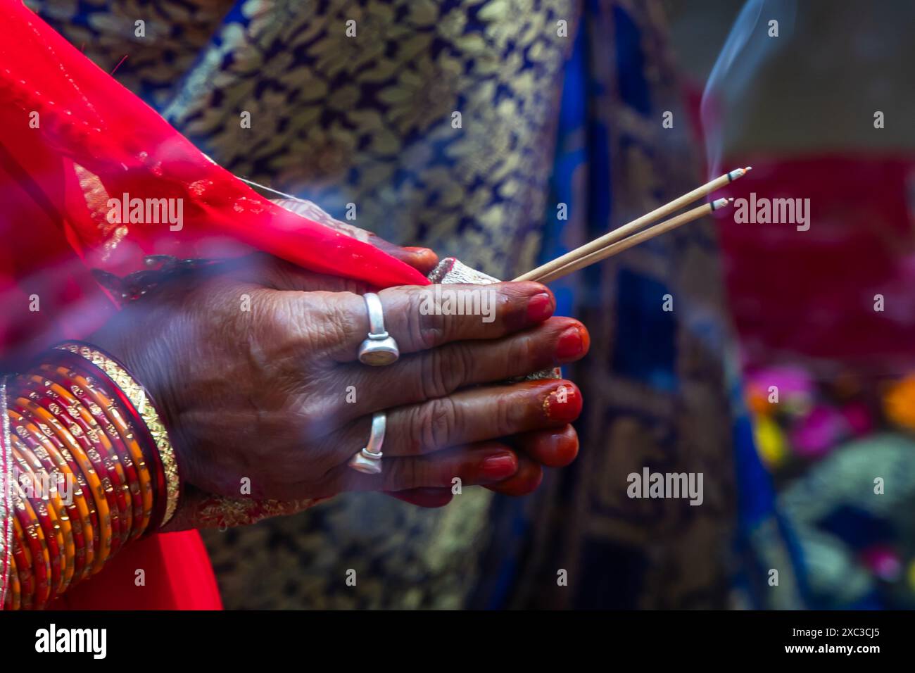 indian devotee worshiping hindu holy god with incense sticks at chhath ...