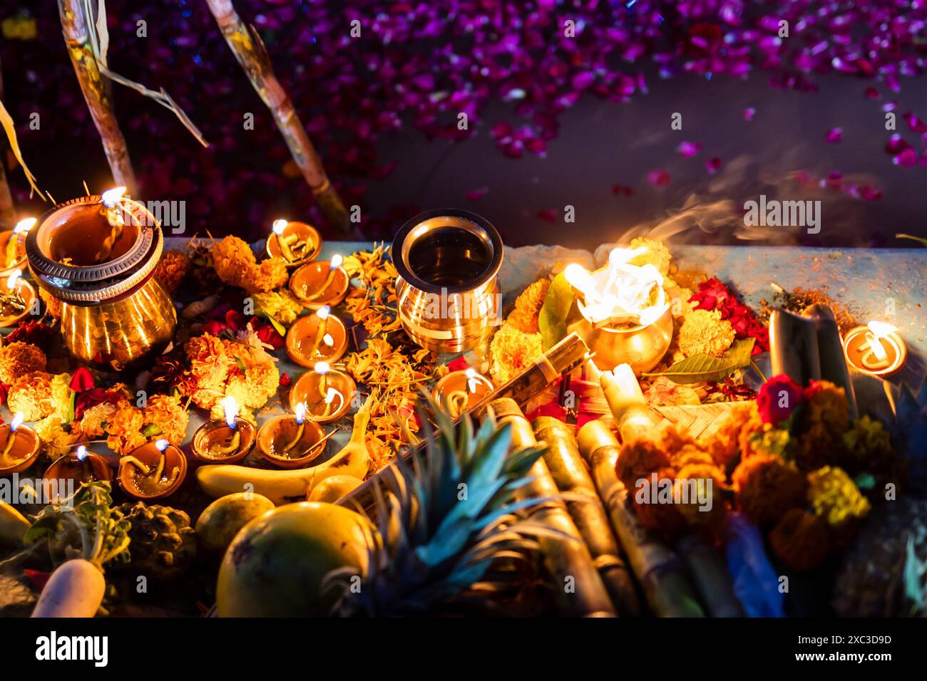 traditional holy offerings of burning oil lamp at river side at chhath ...