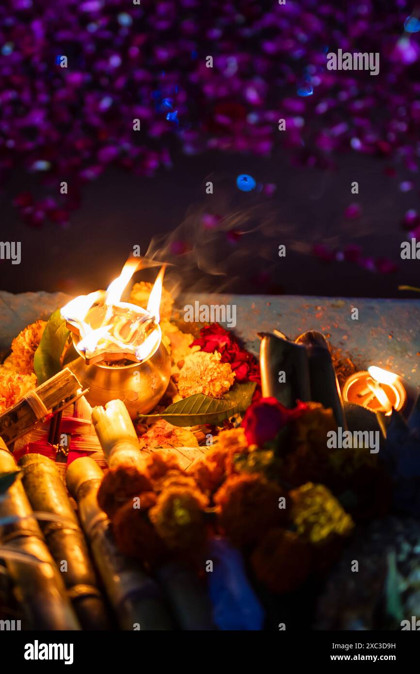 traditional holy offerings of burning oil lamp at river side at chhath ...