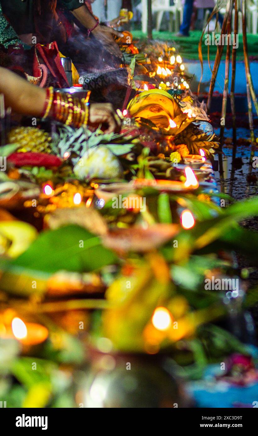 traditional holy offerings of burning oil lamp at river side at chhath ...