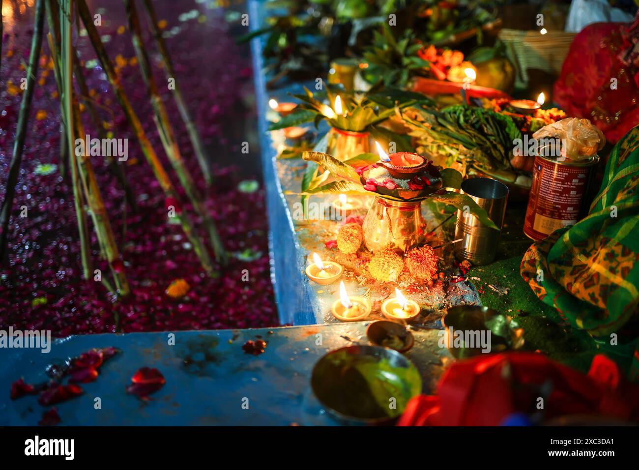 traditional holy offerings of burning oil lamp at river side at chhath ...