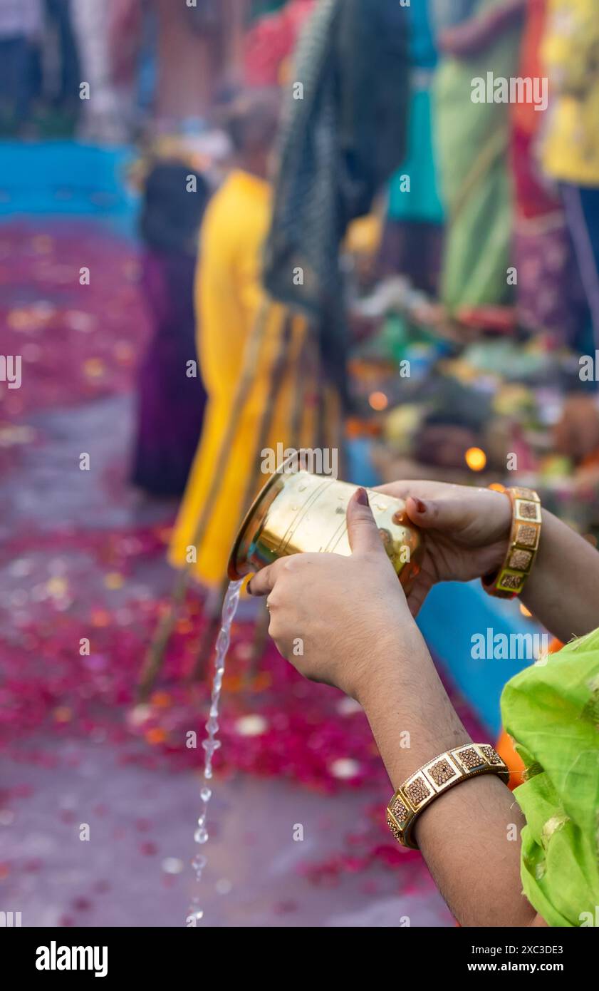 holy water offerings by indian devotee doing traditional rituals at ...