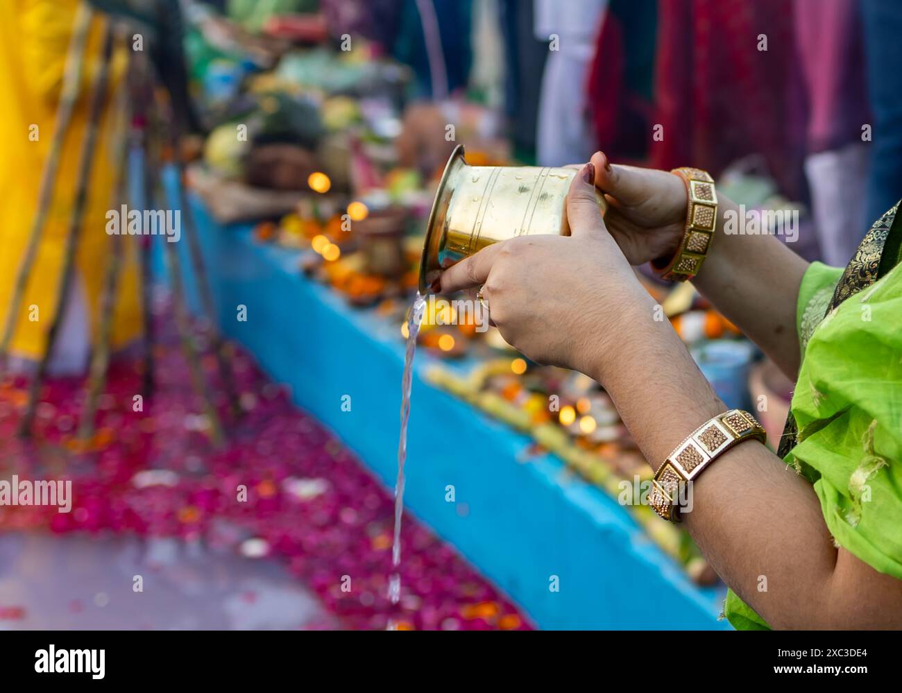 holy water offerings by indian devotee doing traditional rituals at ...