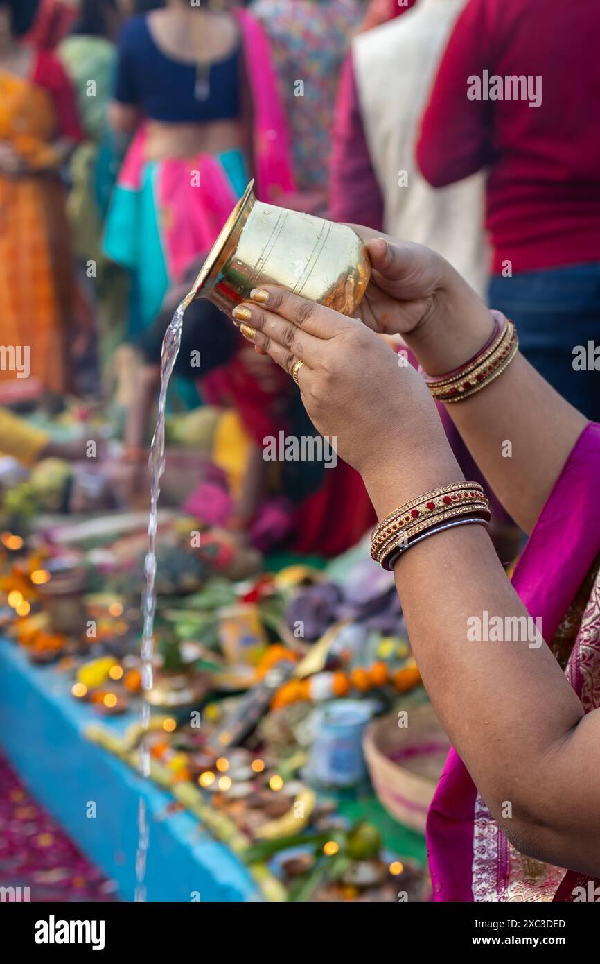 Indian woman pouring water puja hi-res stock photography and images - Alamy