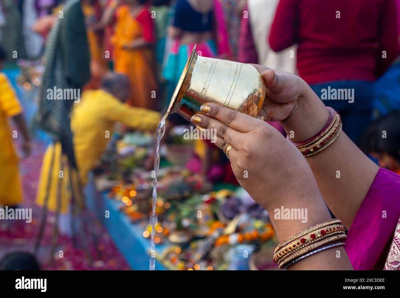 Indian woman pouring water puja hi-res stock photography and images - Alamy