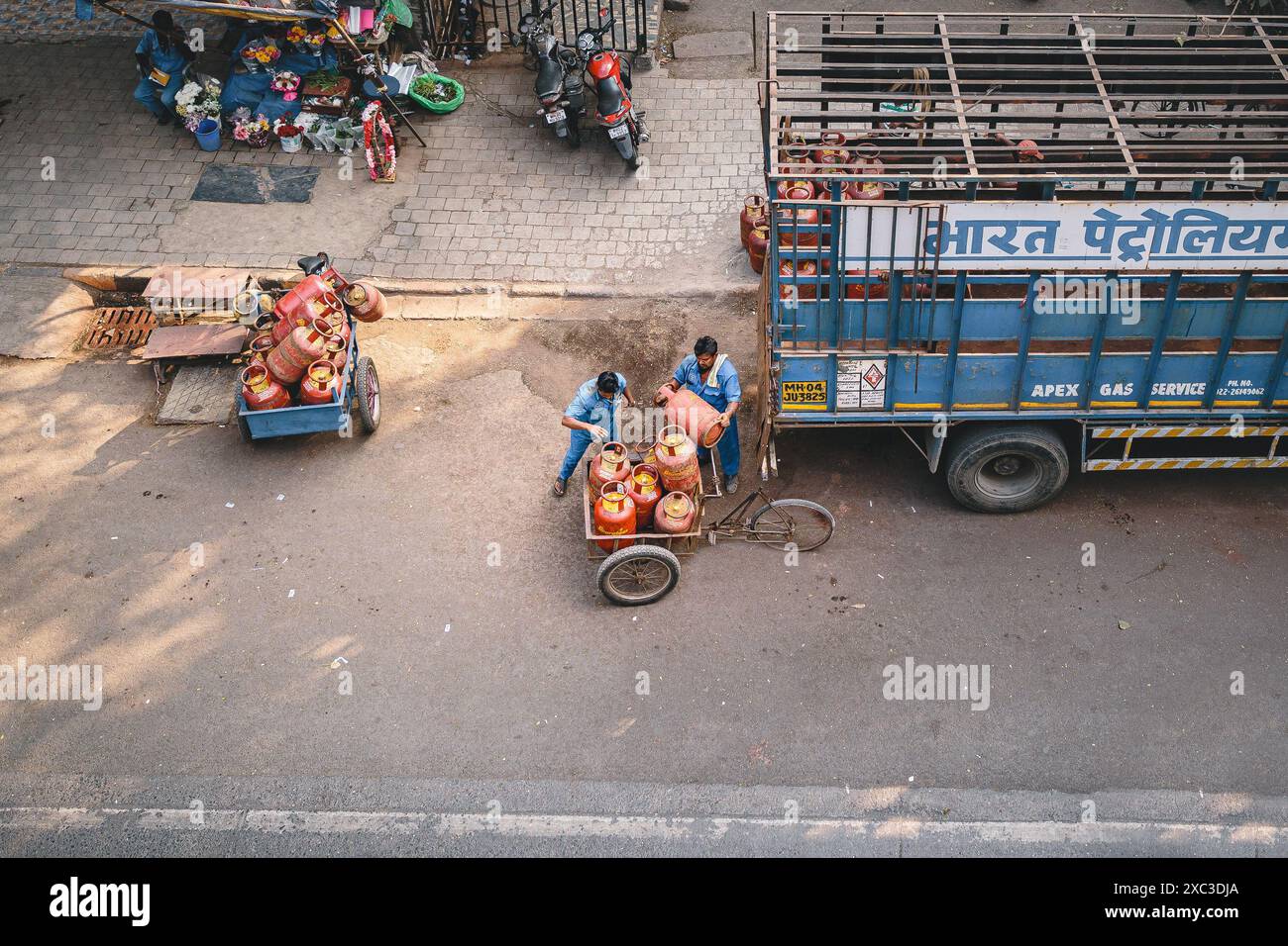 Men handling commercial LPG Cylinders of Hindustan Petroleum (HPCL) on ...