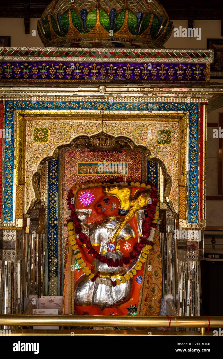 hindu god lord hanuman prying by devotee with offering at temple at day ...