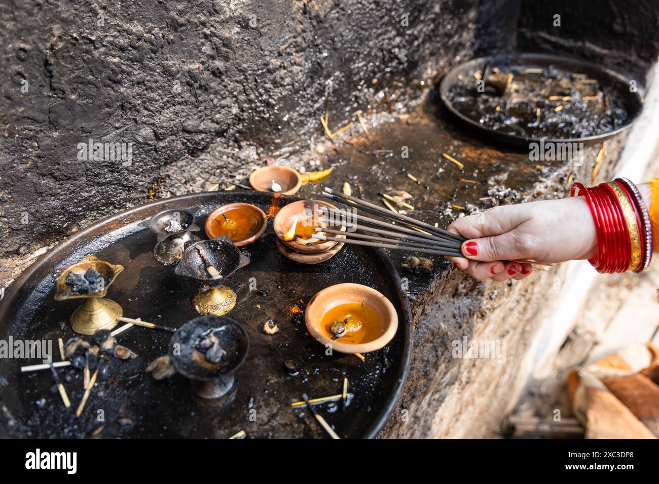 devotee offering the incense sticks at temple at day Stock Photo - Alamy