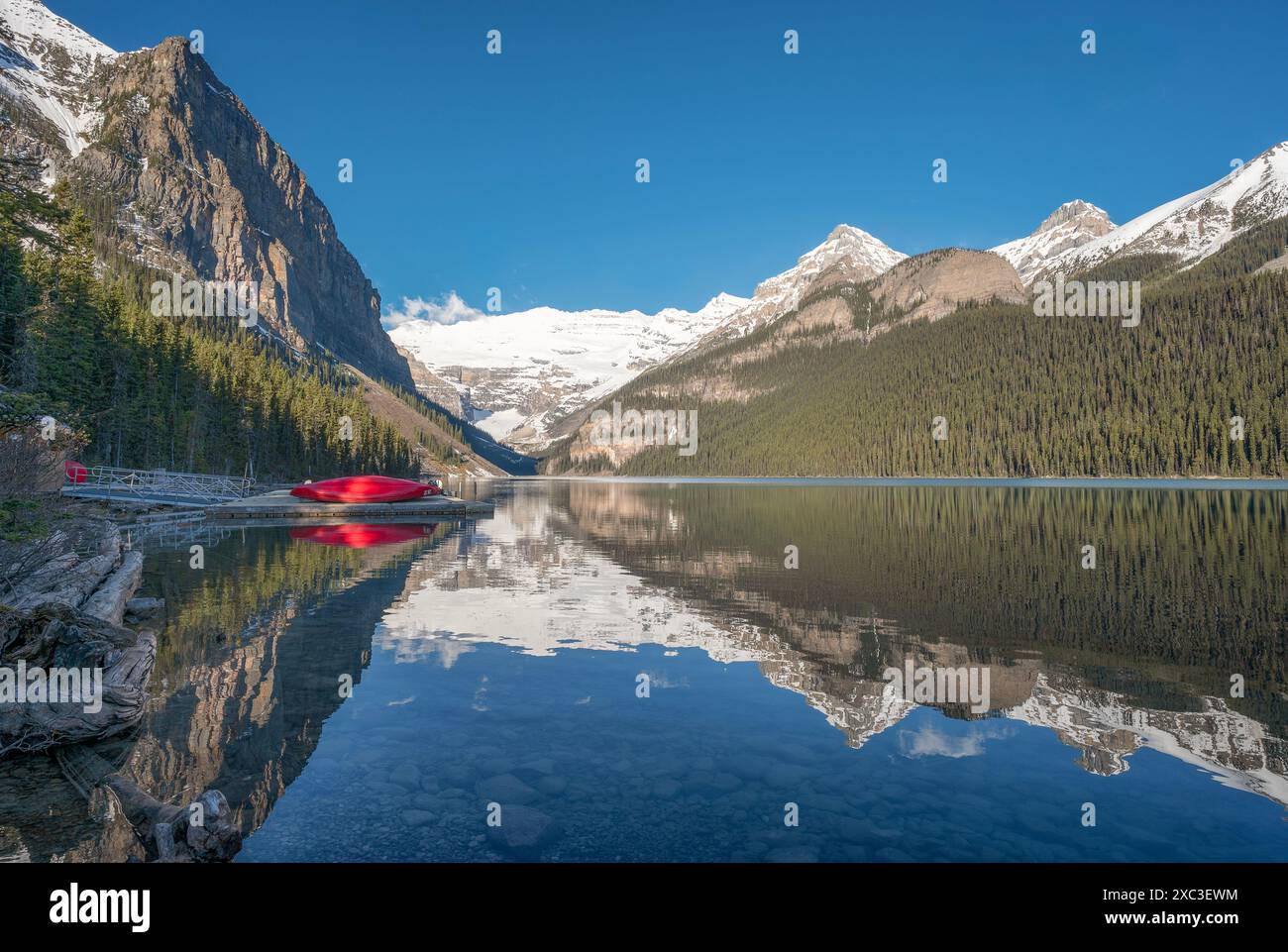 Red Canoes and Mount reflected in Lake Louise in Banff National Park ...