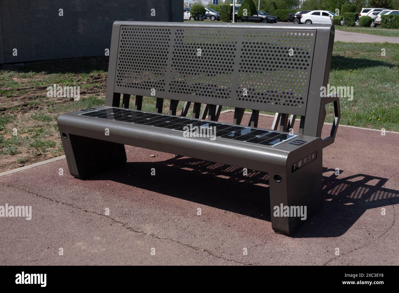 Black street bench with solar battery for charging your phone ...