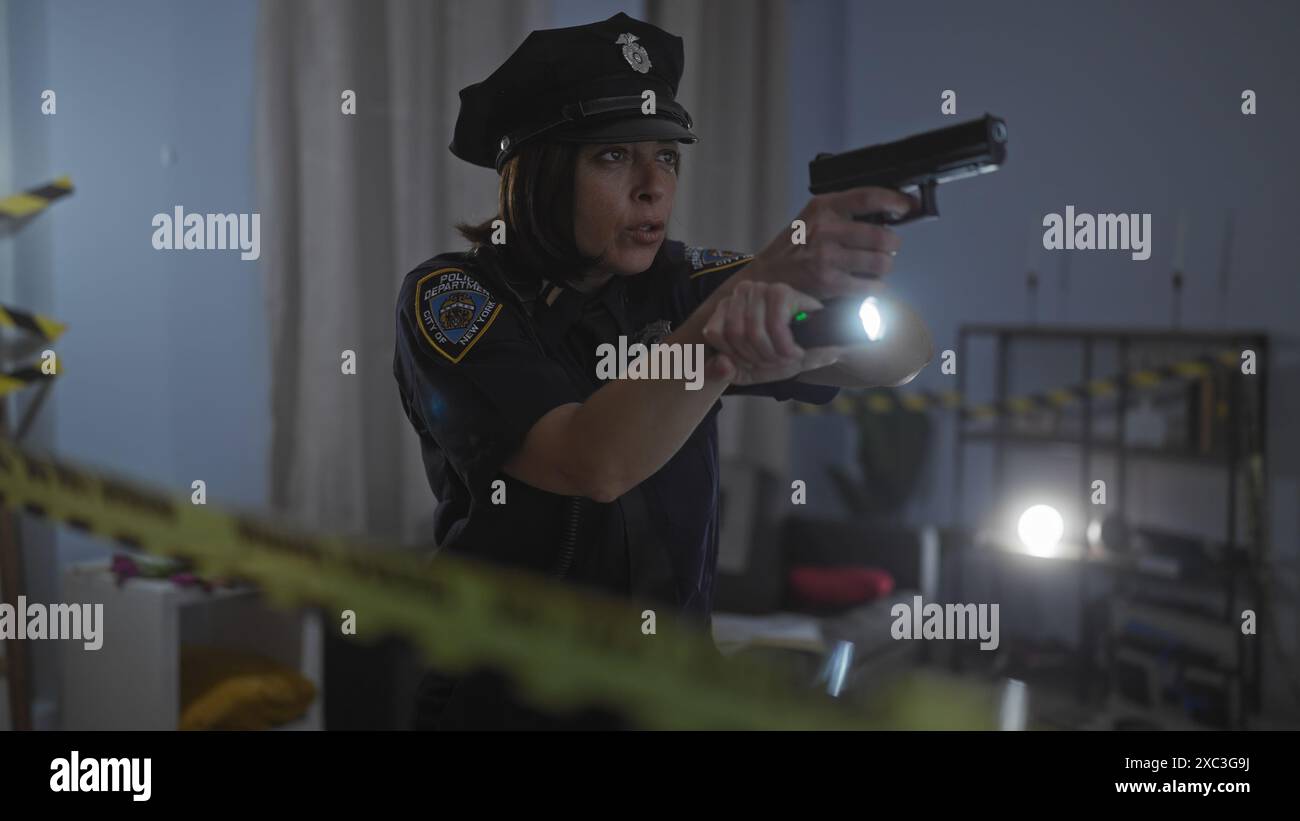 Hispanic woman police officer with gun and flashlight searches room at ...