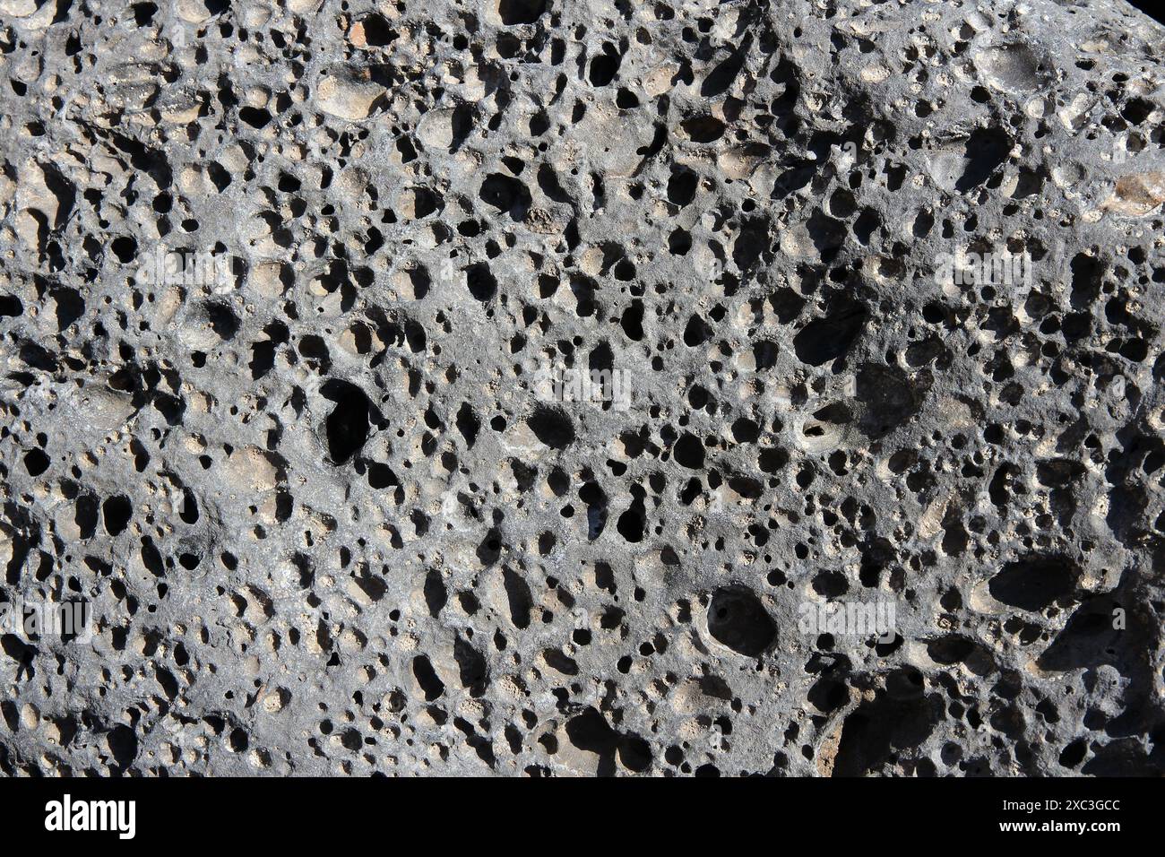 Vesicular basalt rock surface in Tenerife island, Canary islands. Basalt texture with vesicles ...
