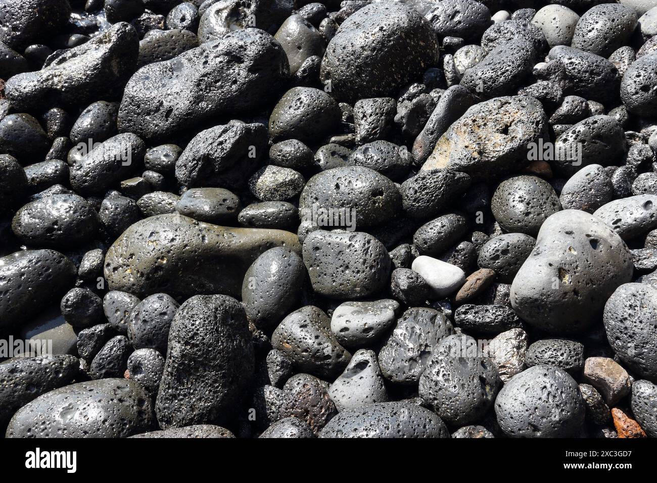 Scoria igneous rocks in Tenerife. Rounded black stones Stock Photo - Alamy