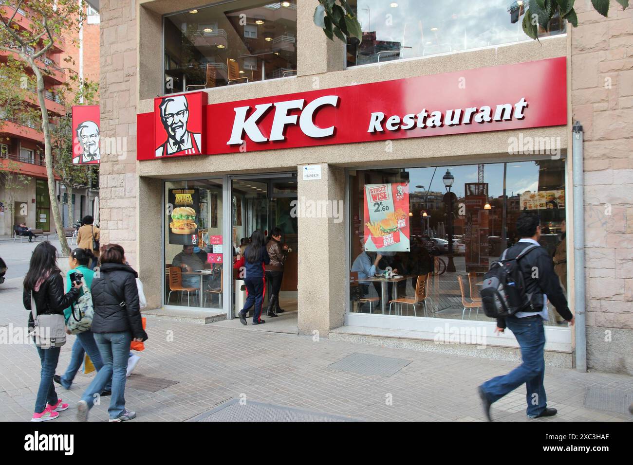 BARCELONA, SPAIN - NOVEMBER 6, 2012: People walk by KFC fast food ...