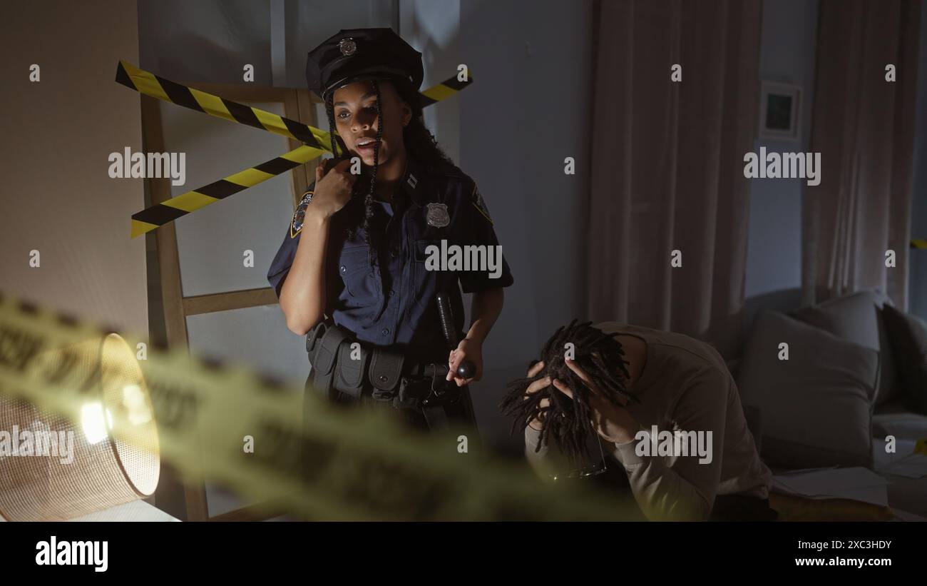 A woman police officer communicates on a radio beside a distressed man ...