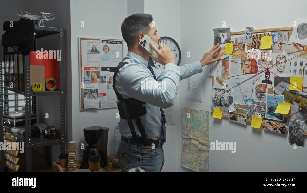 A young hispanic man with a beard examines evidence at a police station ...