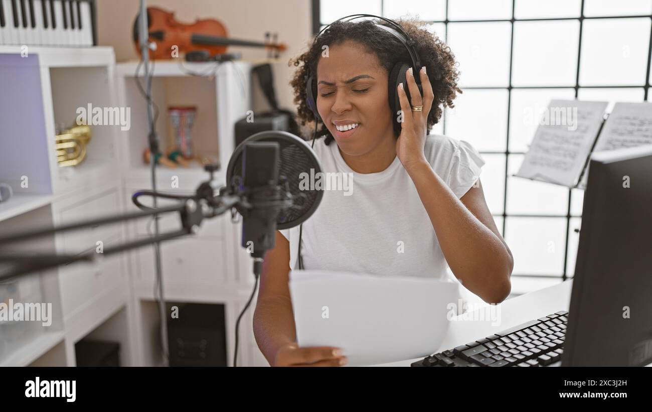 Black female singer recording vocals in music studio Stock Photo - Alamy