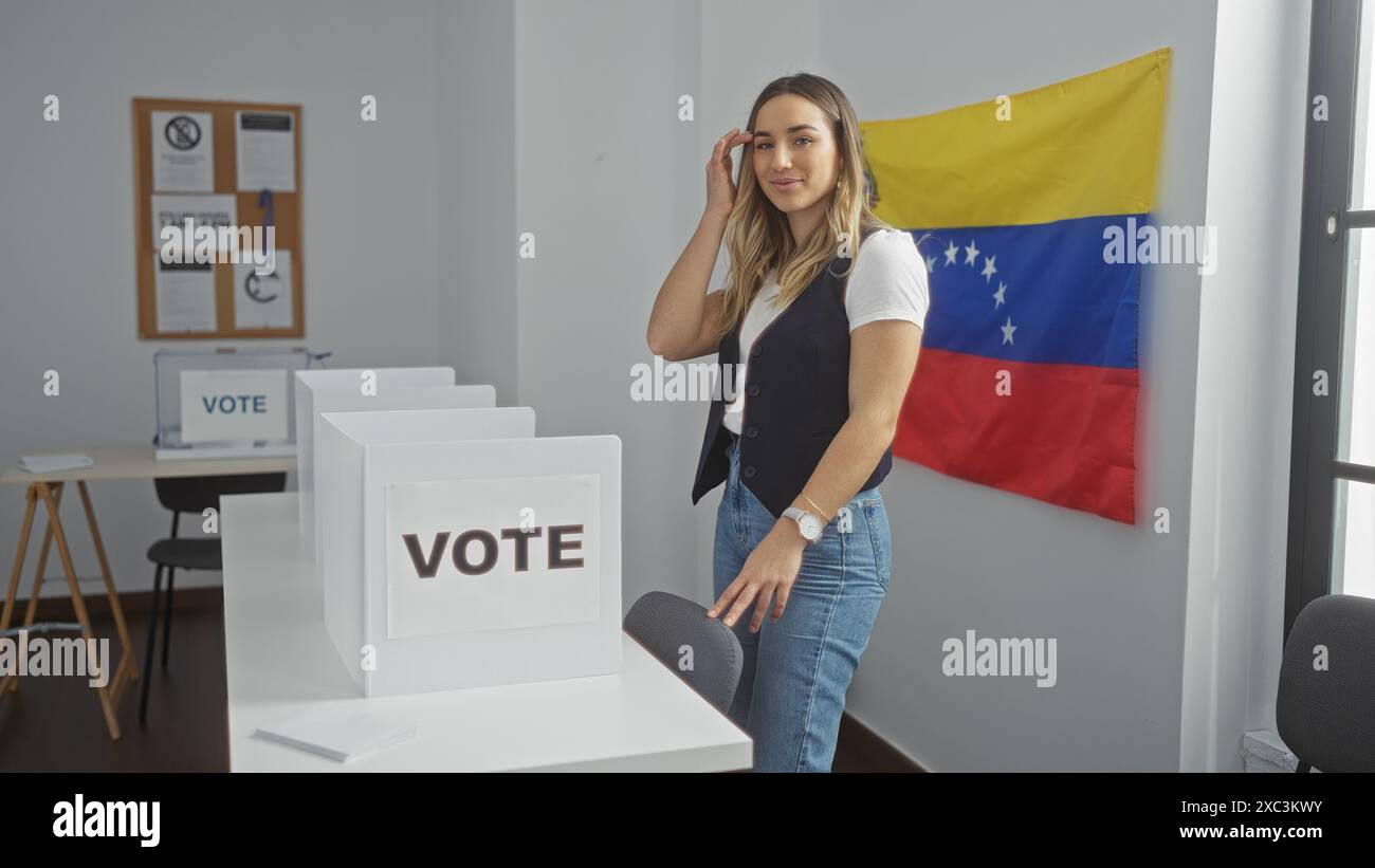A young attractive blonde woman stands in an indoor voting room with ...