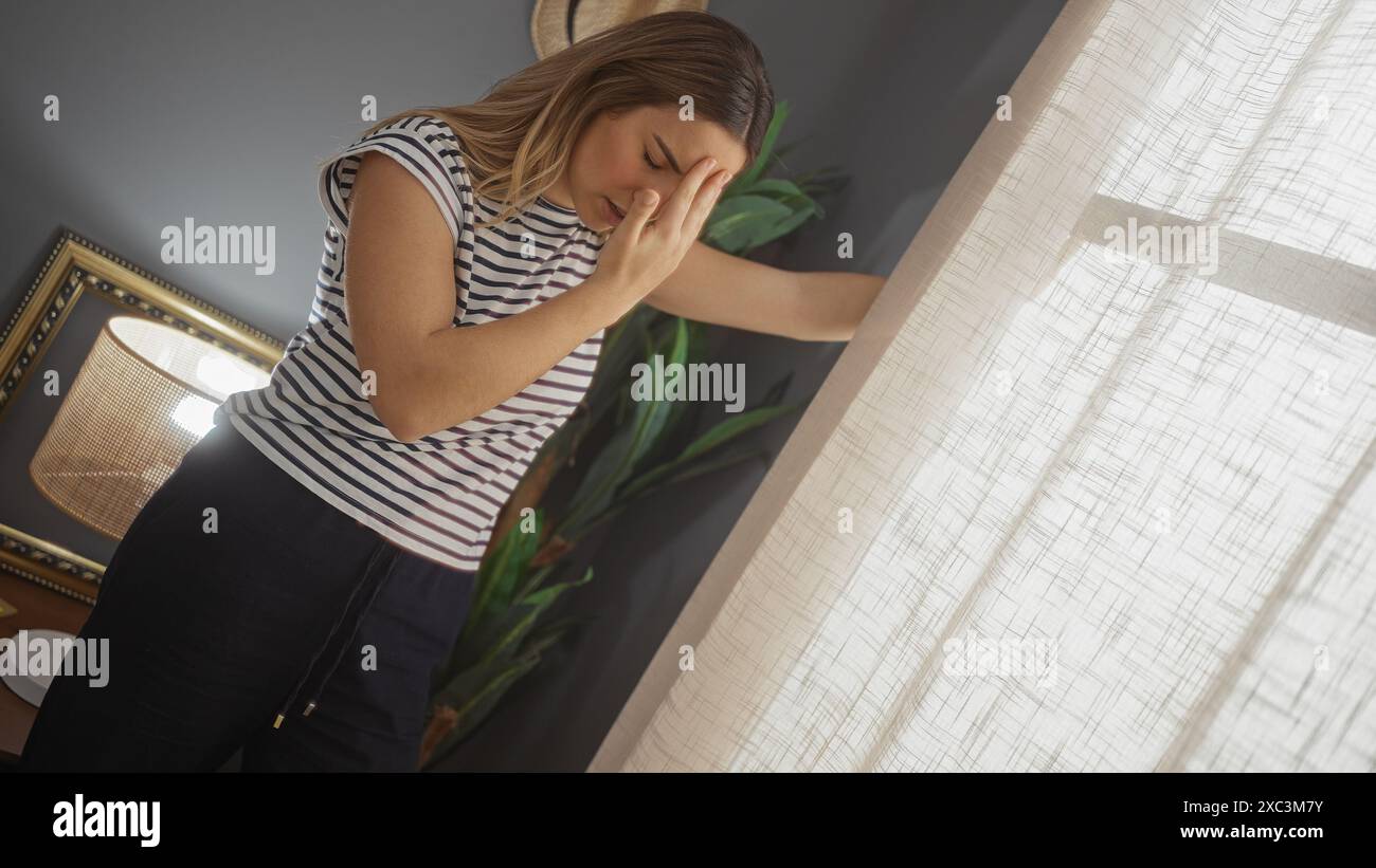 A beautiful blonde woman appears dizzy, leaning against the wall in an ...