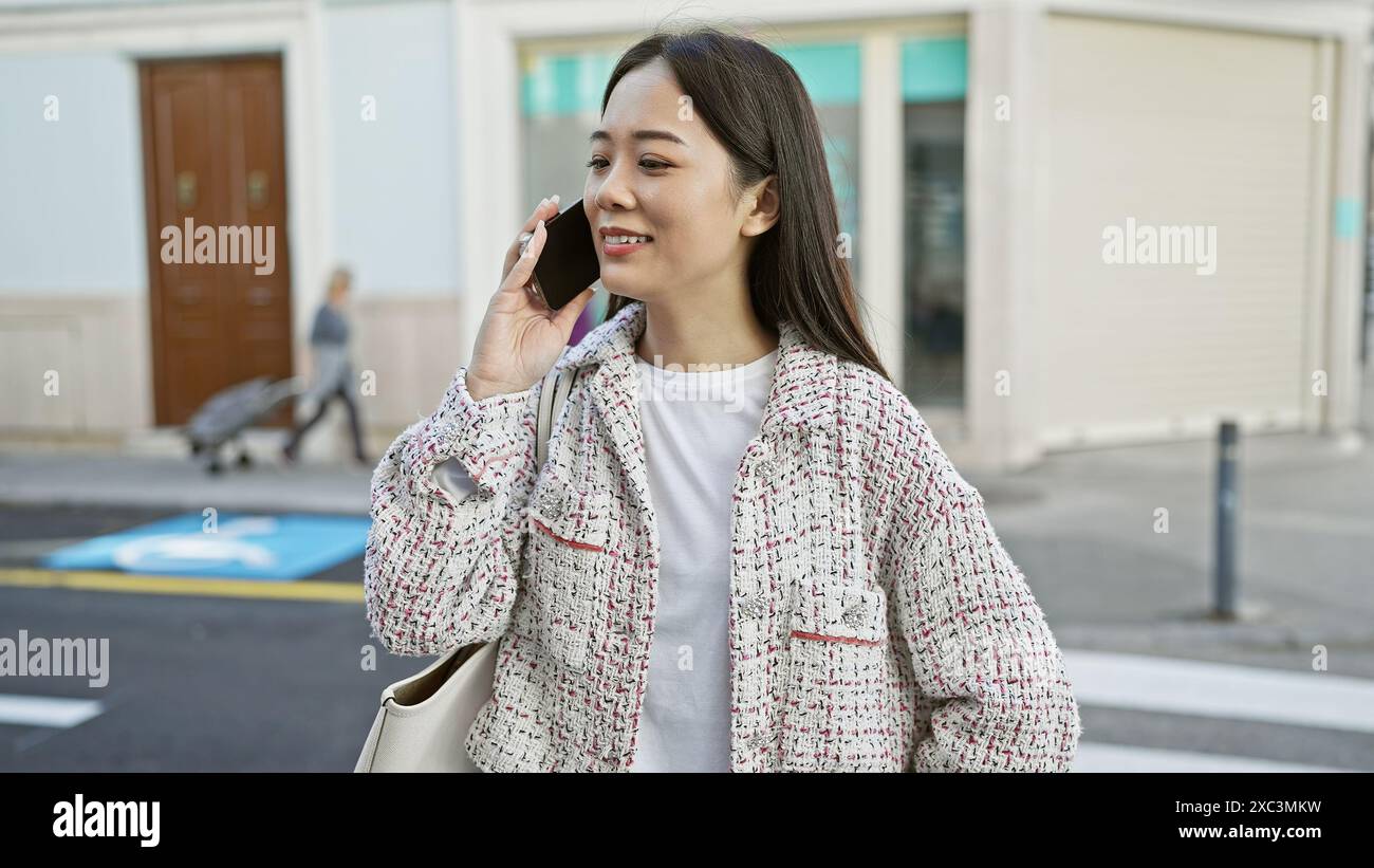 Asian woman on phone walks city street, evoking urban lifestyle and ...