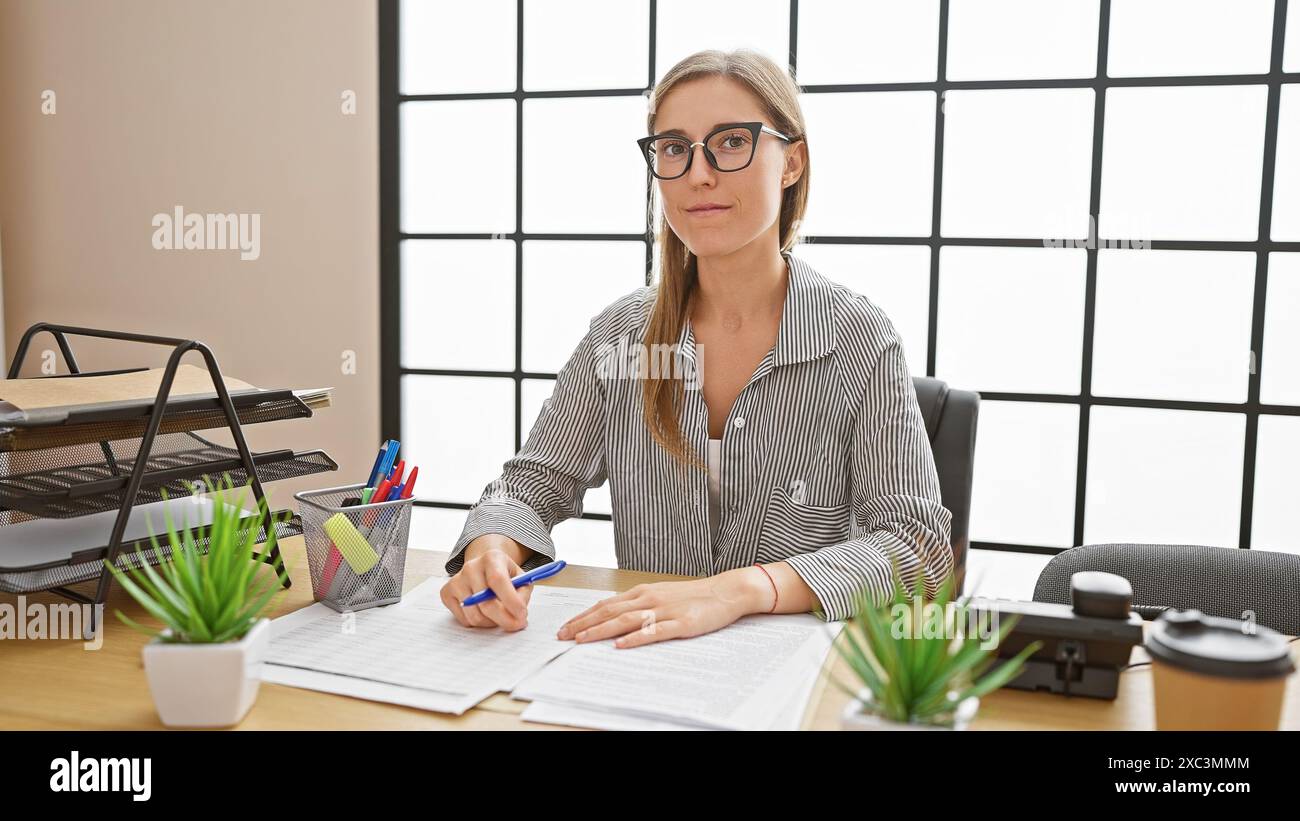 Focused caucasian woman working diligently in a modern office ...