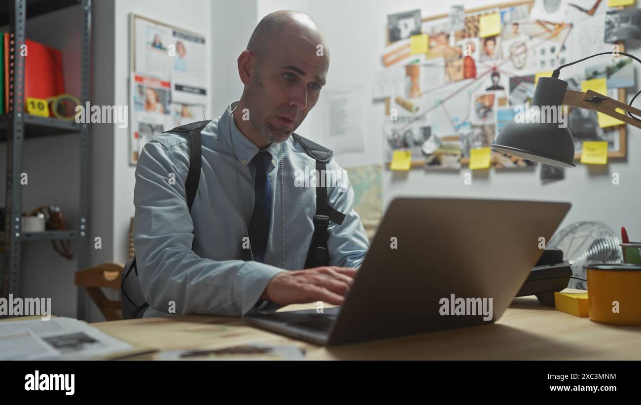 Hispanic man with beard works at laptop in police department office ...