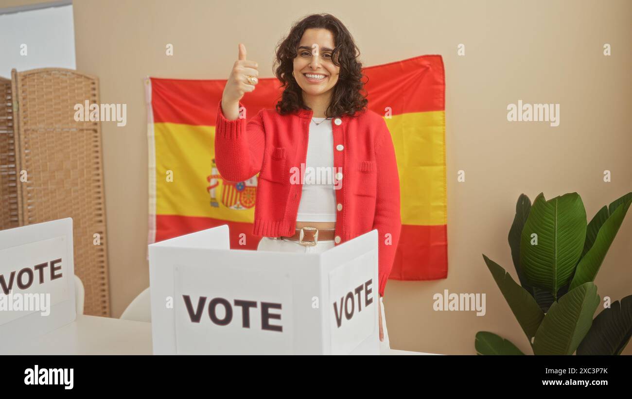 A young hispanic woman is seen voting indoors in front of a spanish ...
