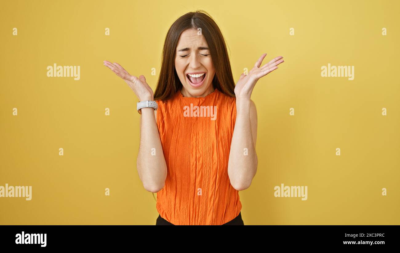 A distressed woman in orange gestures in frustration against a yellow ...