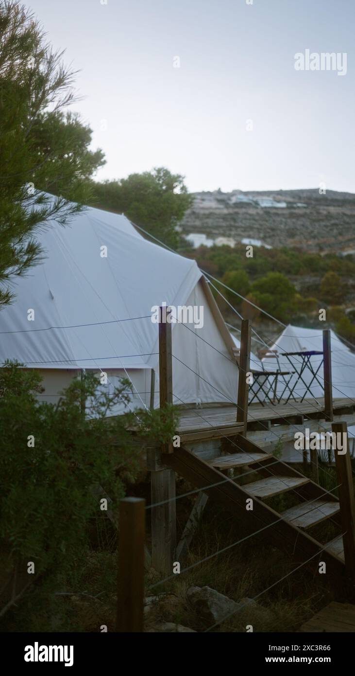 Tented campsite in african wilderness featuring wooden platform tents ...