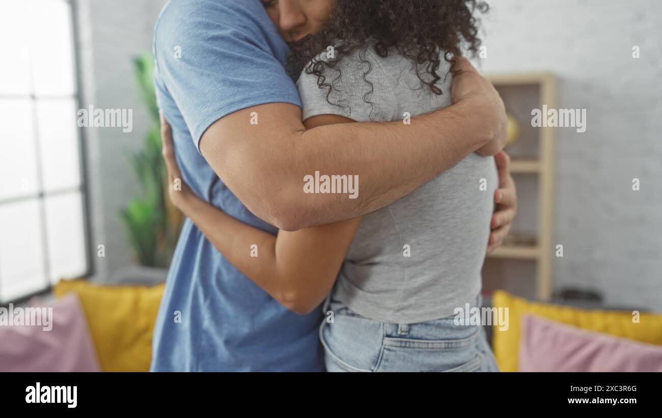 A loving couple embraces warmly in a cozy living room, depicting ...