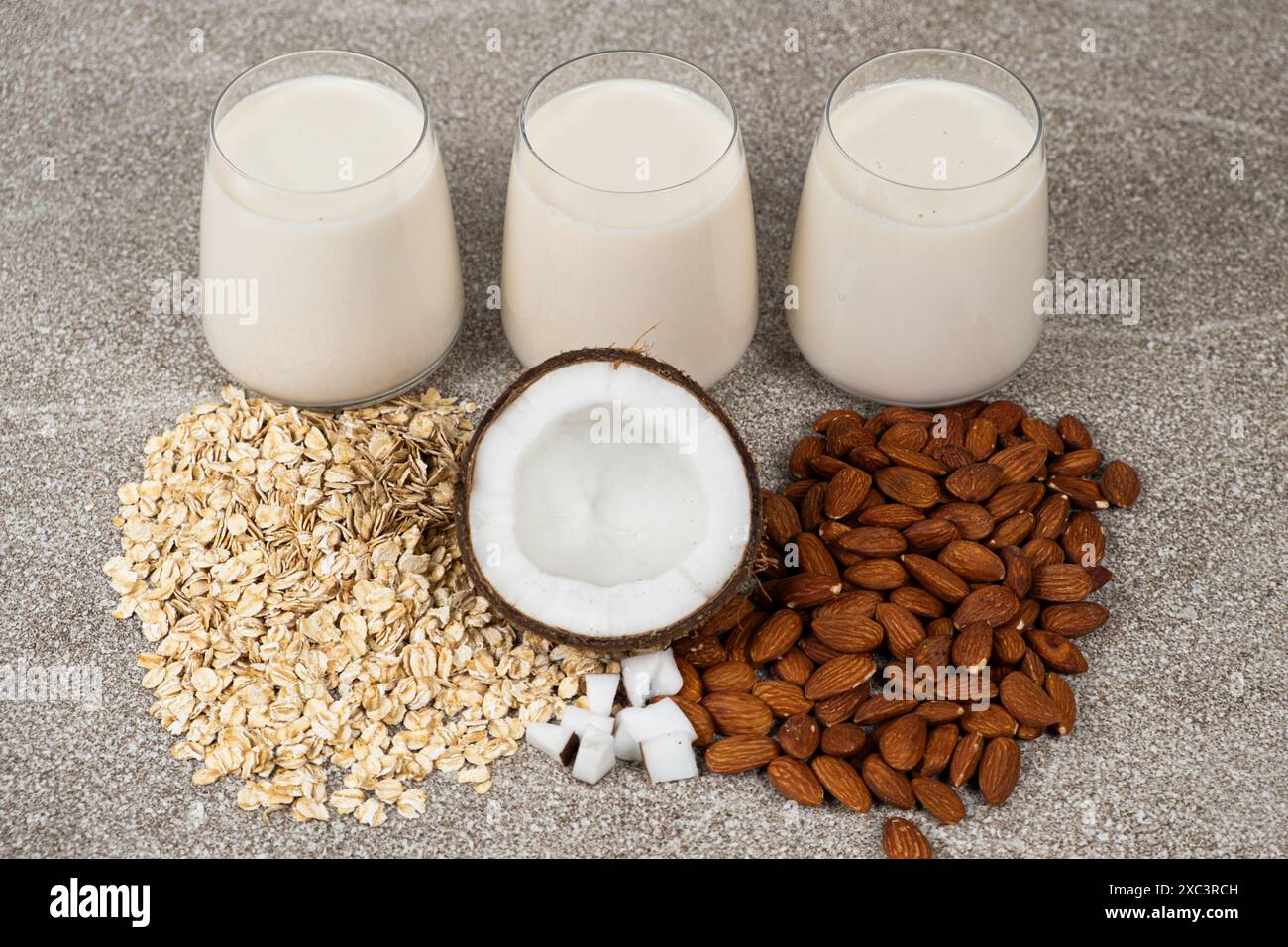 Types of plant-based milk in glasses. Oat, coconut and almond milk ...
