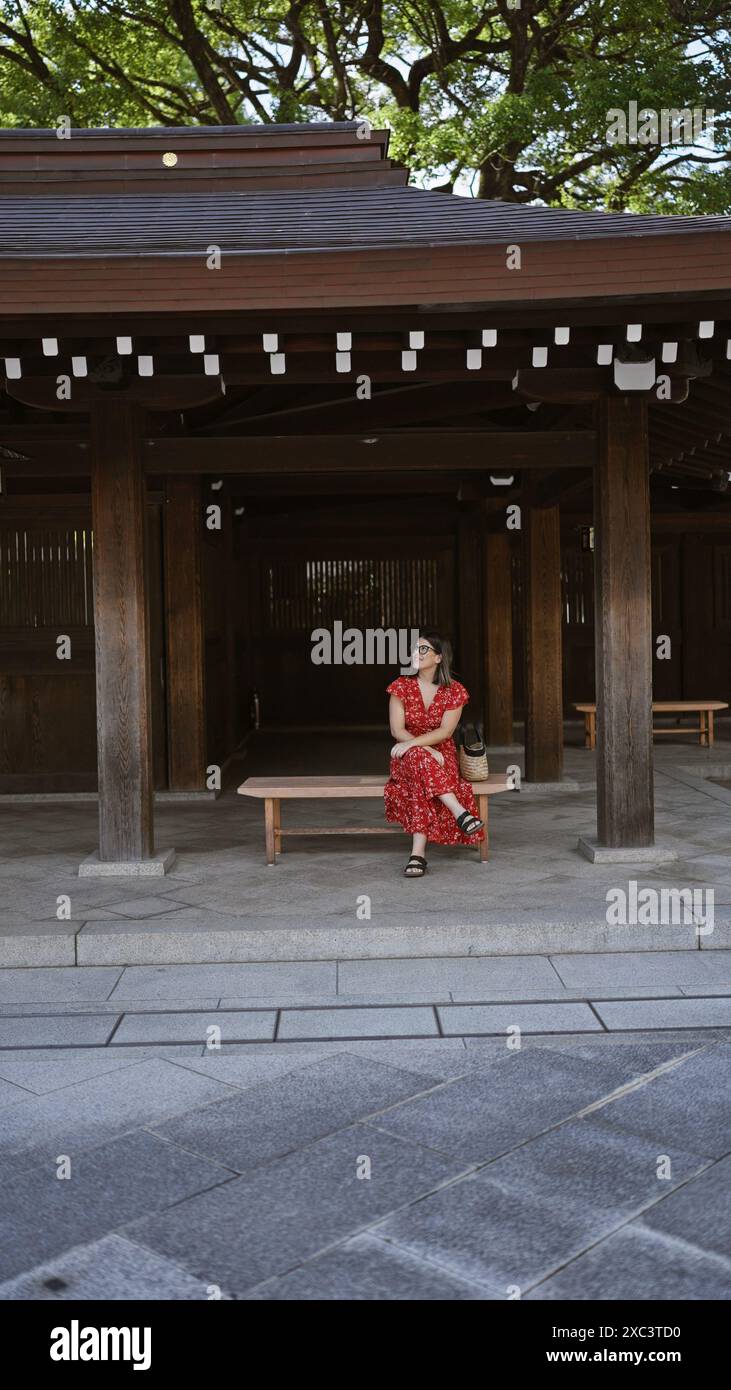 Bright summer at meiji temple, beautiful hispanic woman in glasses, radiating positivity while ...