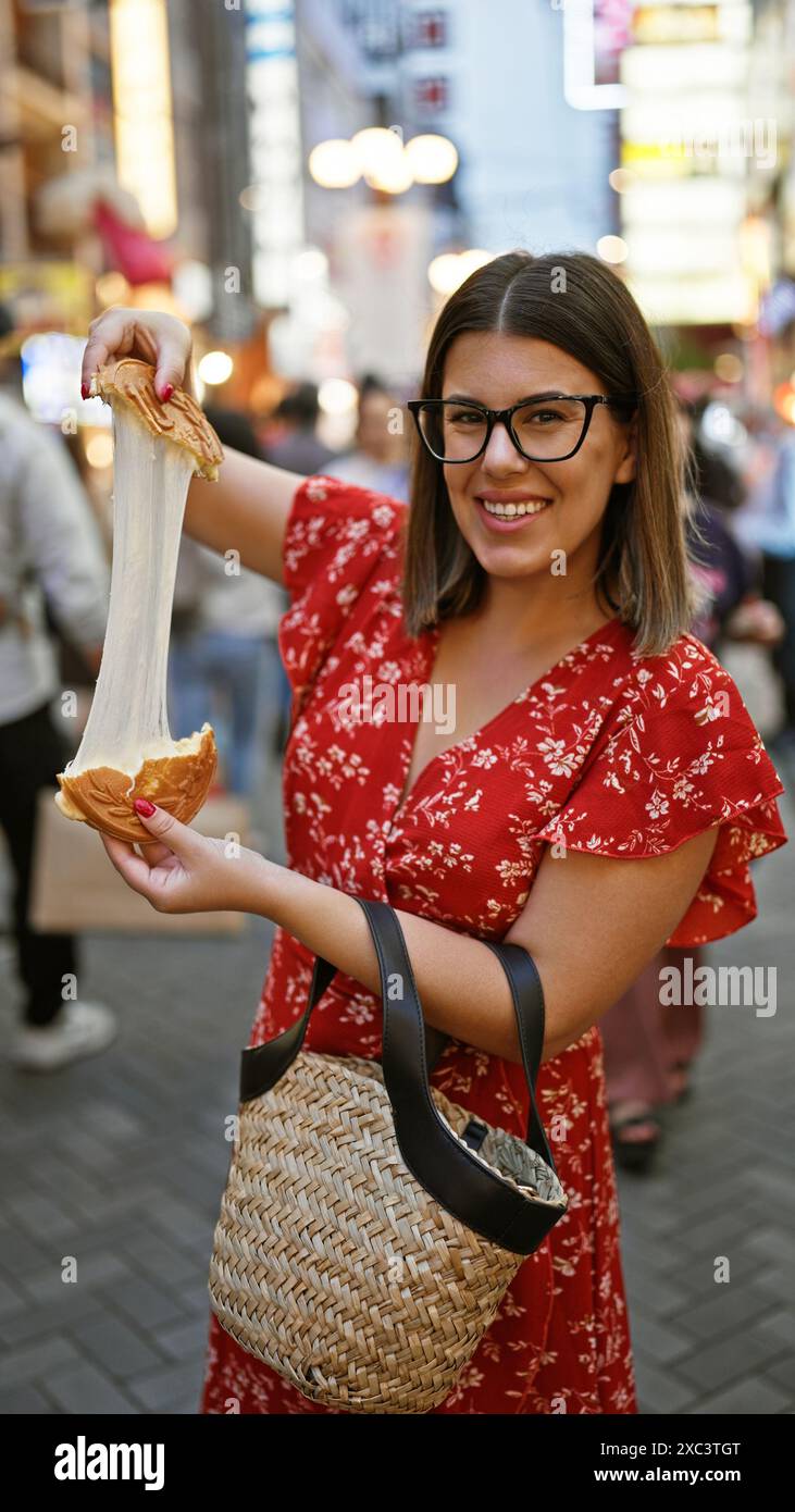 Beautiful hispanic woman in glasses enjoys a chewy, tasty, cheesy 10 ...