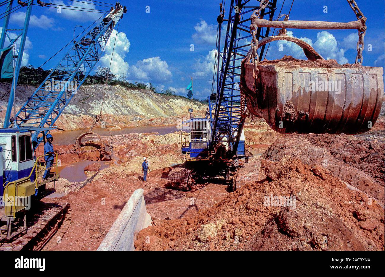 Suriname - Excavators at the bauxite mine fill a truck with bauxiet ore ...