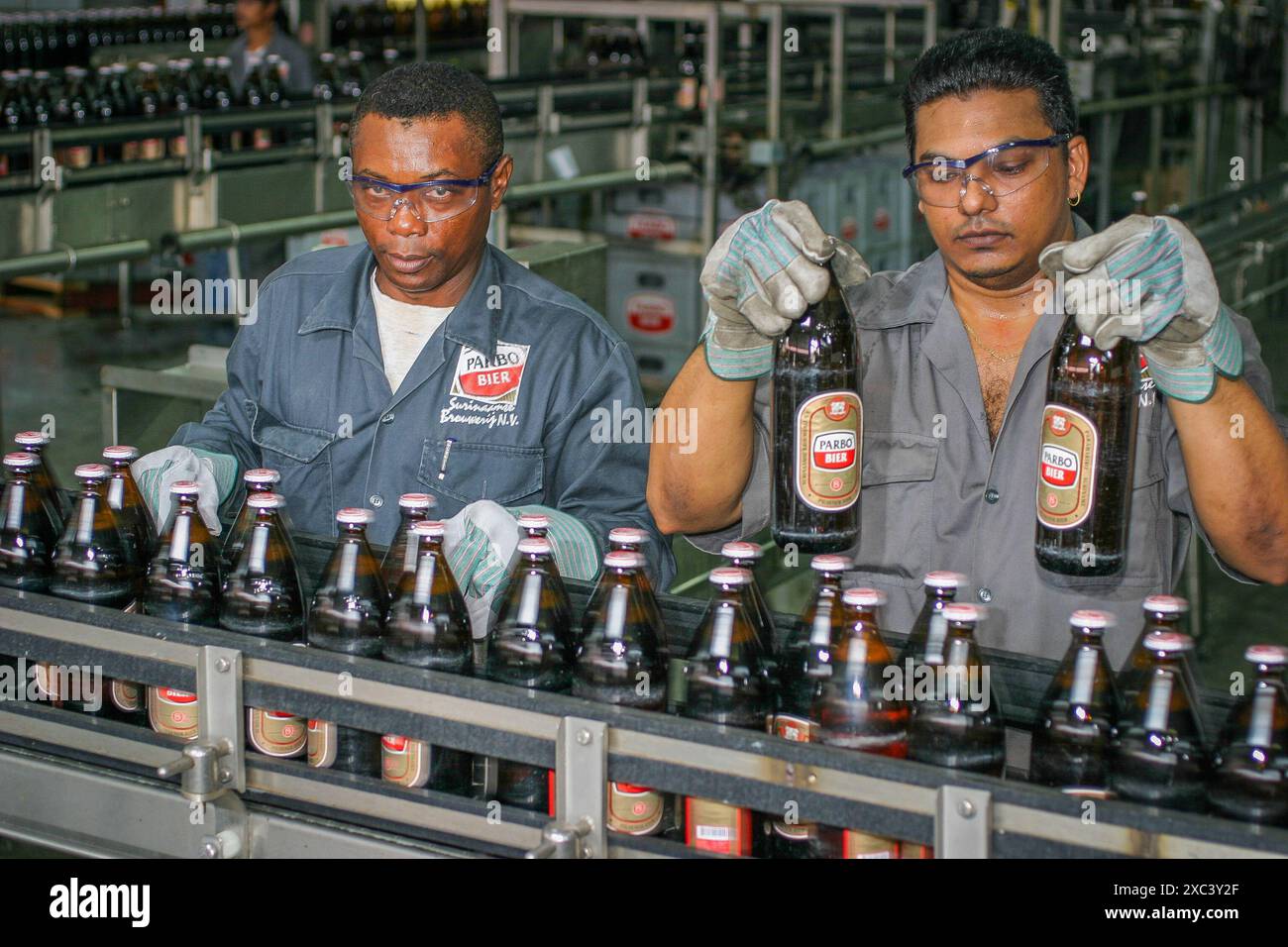 Suriname, Paramaribo - Factory workers of the Parbo beer brewery, a ...