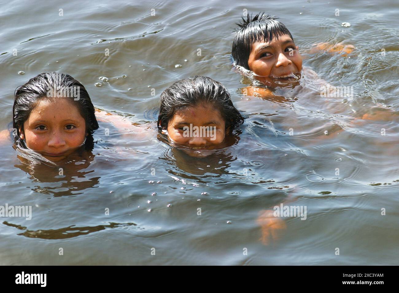 Suriname, Tepu. Girls of the Trio tribe are playing in the river Stock ...