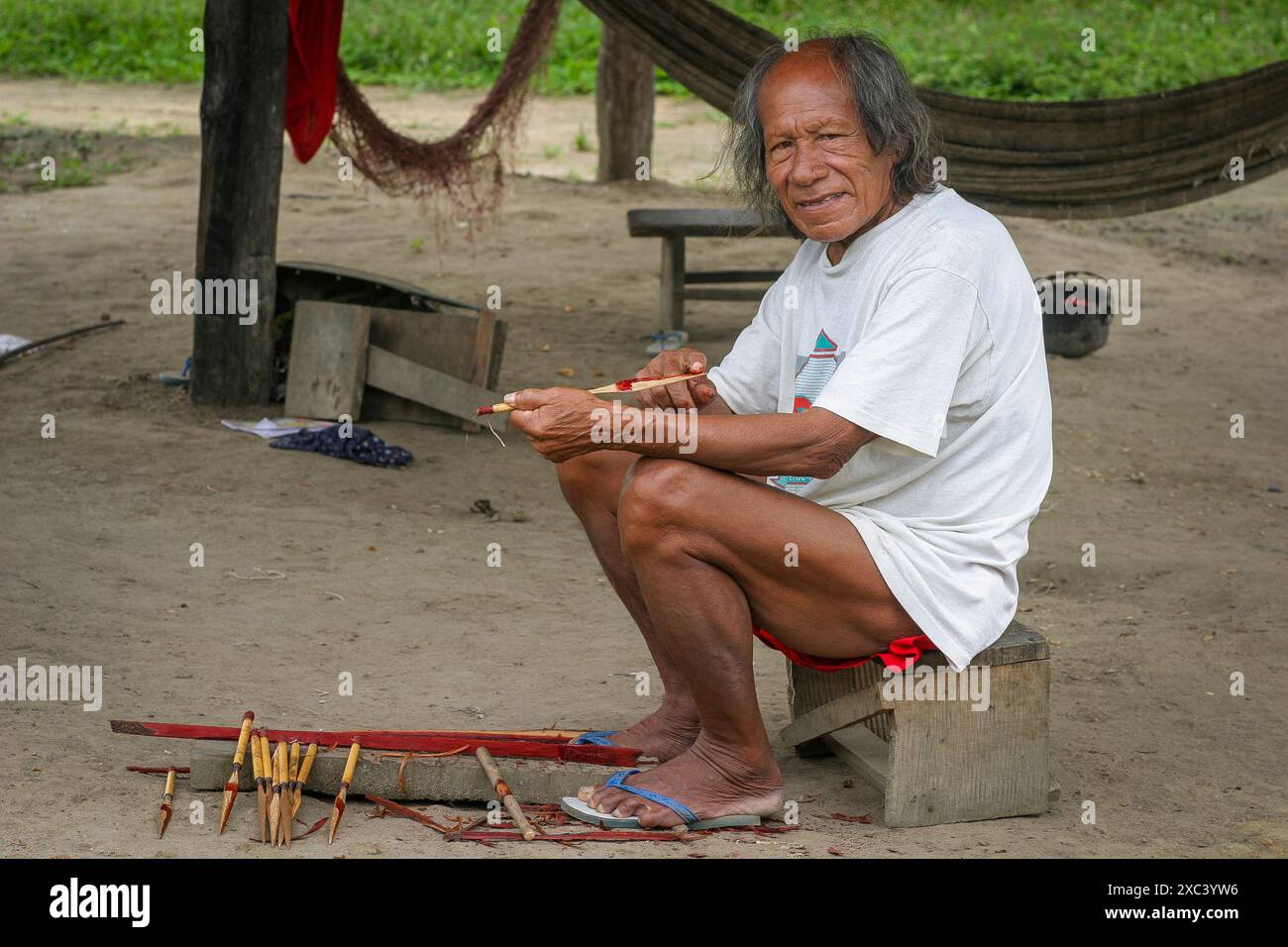 Suriname, man from the Trio tribe prepares wooden arrowheads with ...