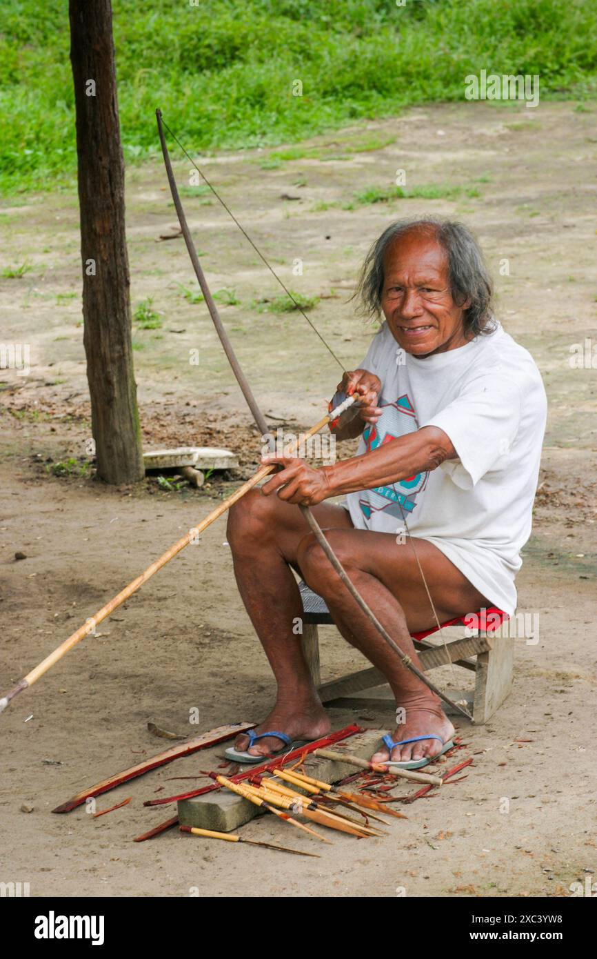 Suriname, man from the Trio tribe prepares wooden arrowheads with ...