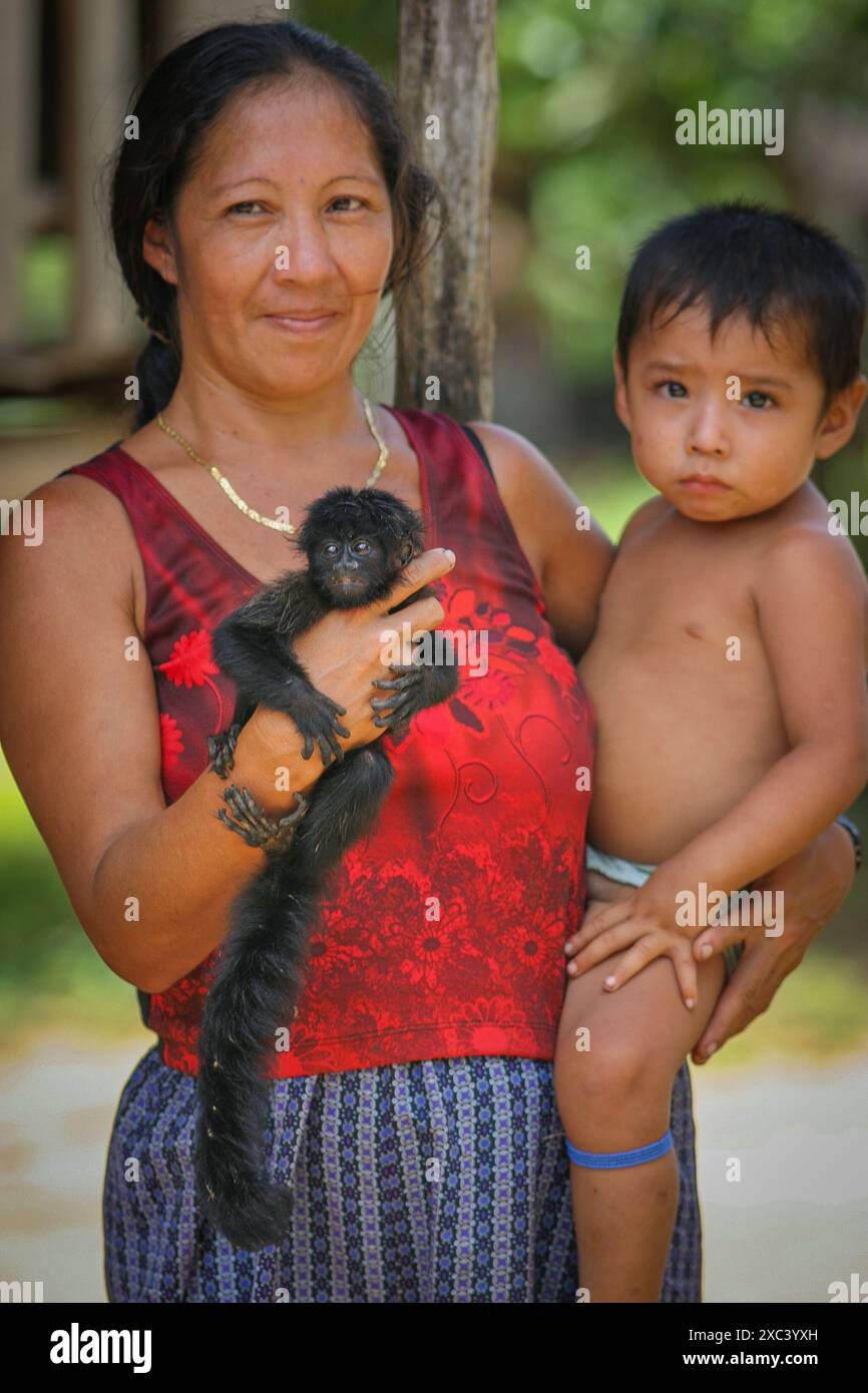 Suriname, Tepu. Portrait of a mother and child of the Trio tribe with a ...