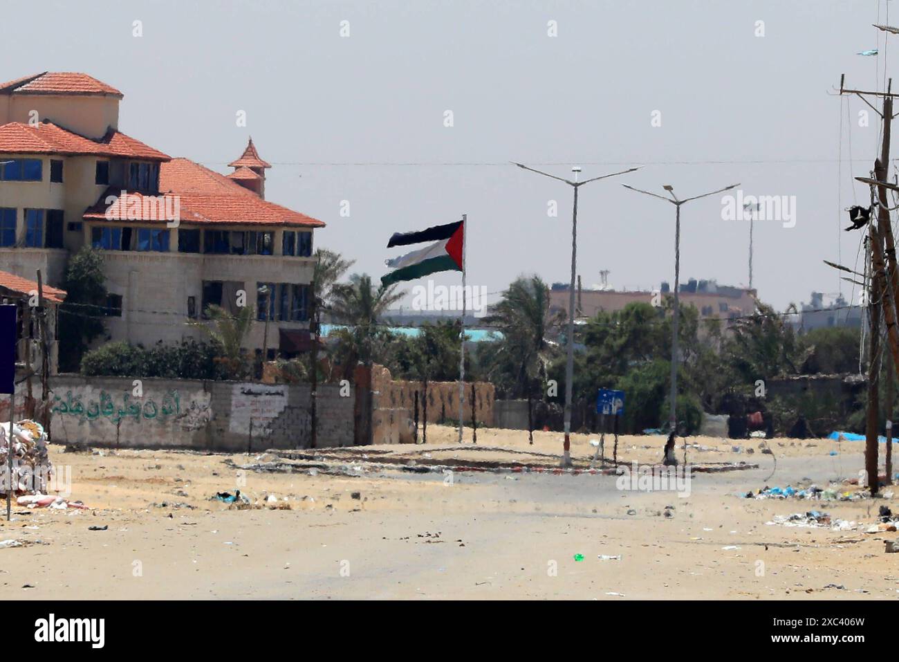 A fraying Palestinian flag flies near a field hospital of the ...