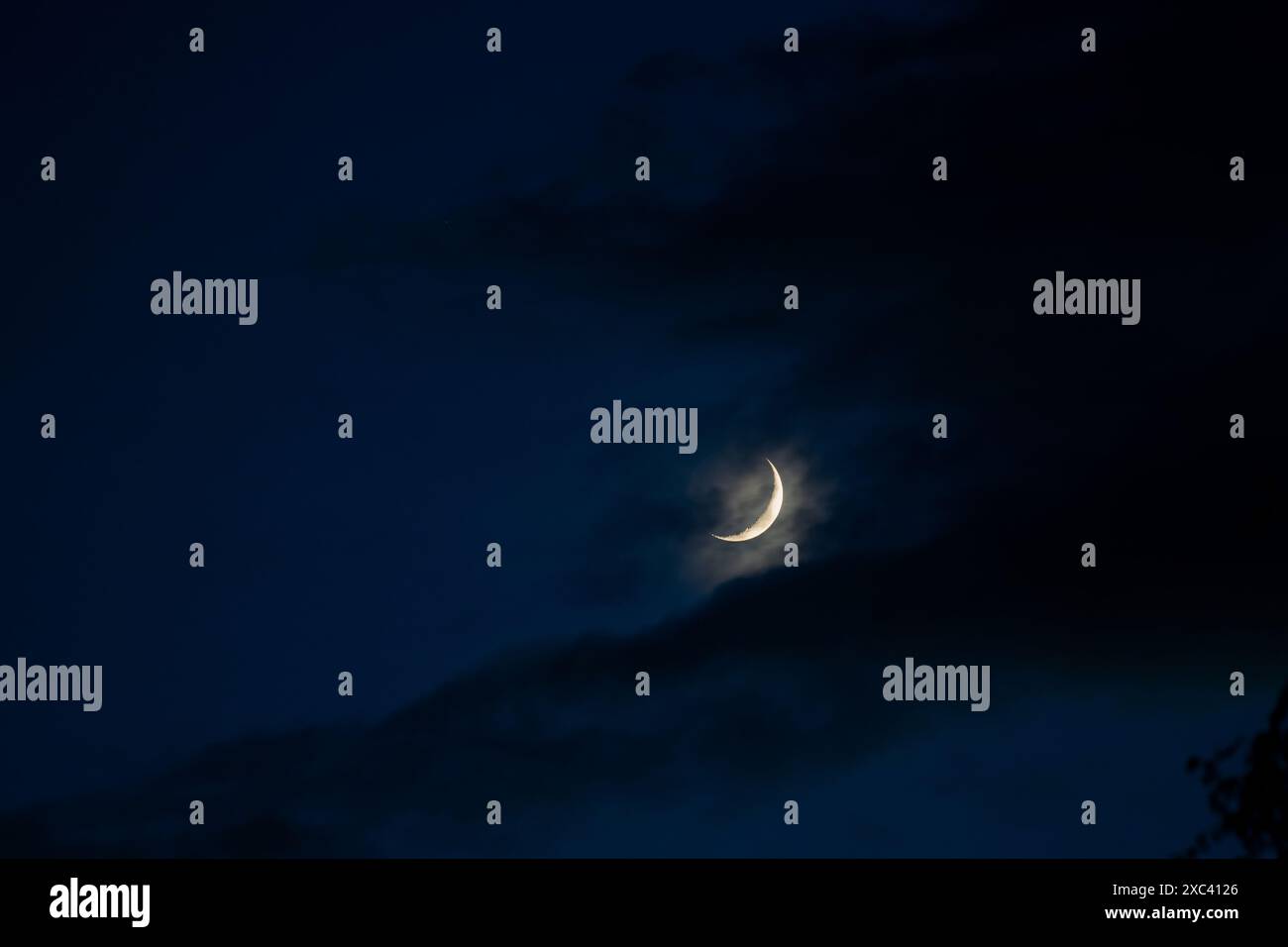 Real photograph of Crescent moon on black sky through the clouds Stock ...