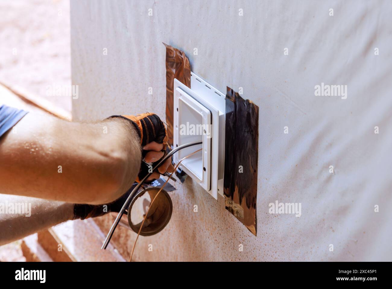 Weatherproof deep plastic electrical box is mounted on outside wall ...