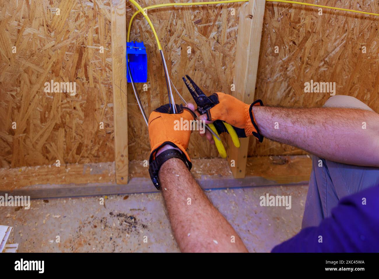 Installing electrical wires on residential construction site by an ...