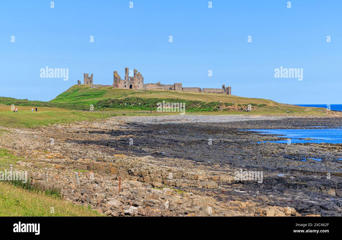 Panoramic shoreline view towards 14th century Dunstanburgh Castle ruins ...
