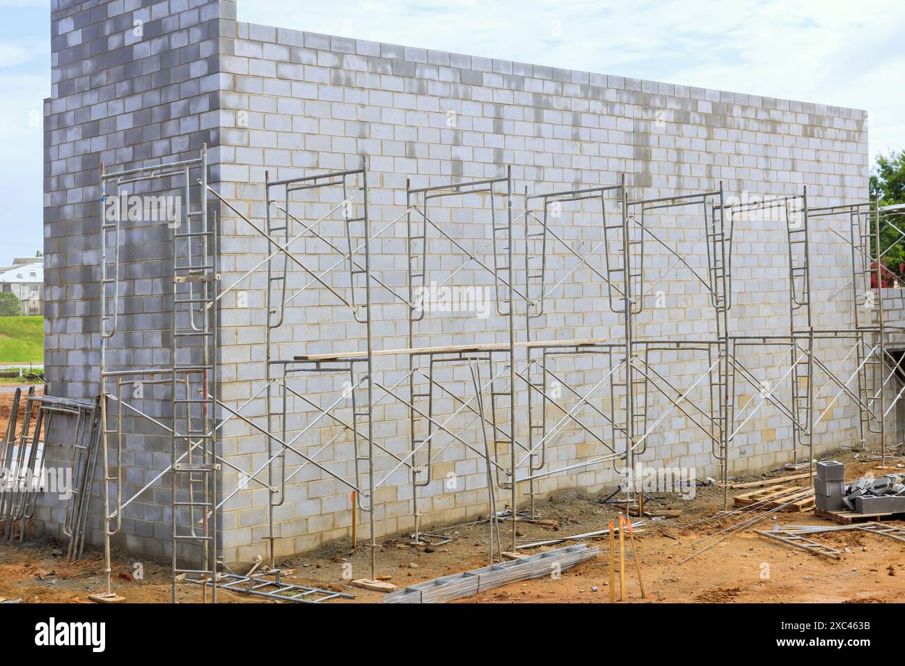 During construction, mason makes concrete wall from cement blocks while ...