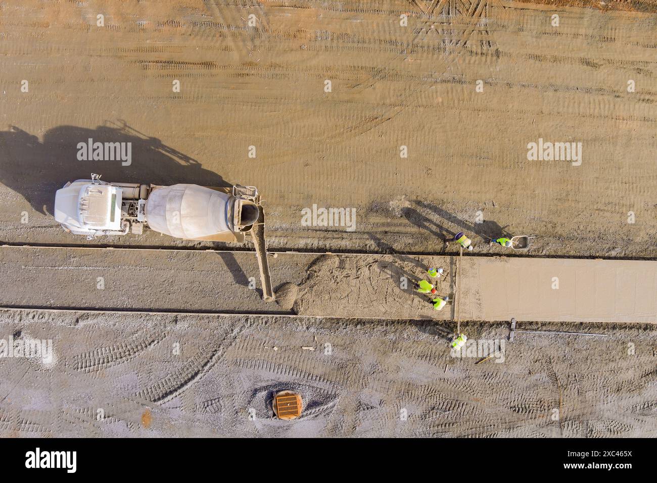 Mason workers introduce concrete pouring process from mixer truck for ...